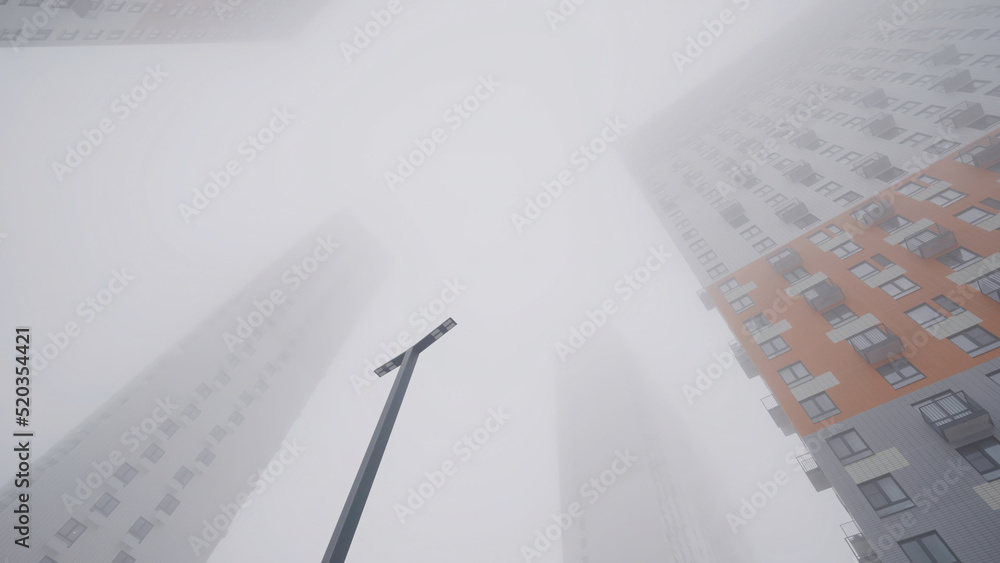 Foto de Residential high-rise buildings in fog. Action. Bottom view of ...