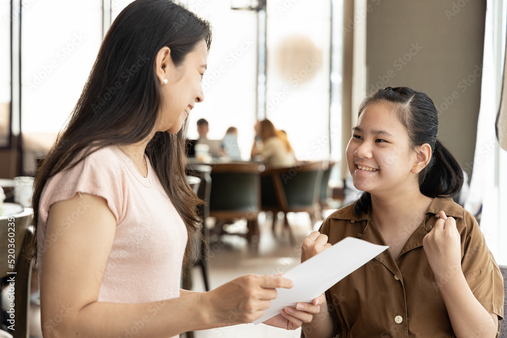 Clever primary school daughter getting excellent grade from the exam ...