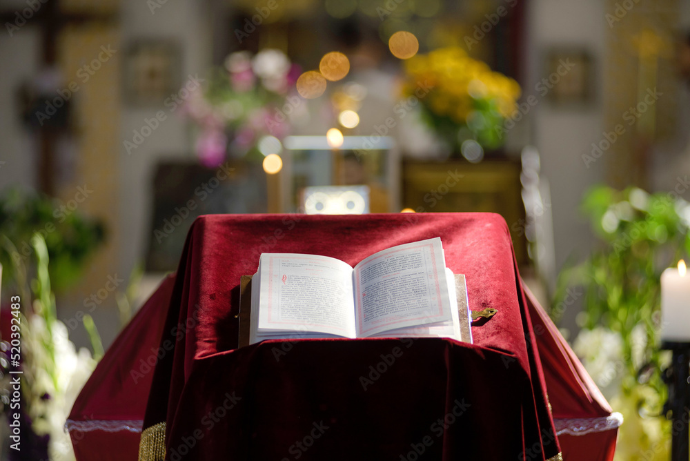 The liturgical book lies on the lectern in the middle of the Orthodox ...