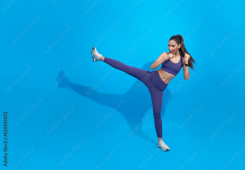 Asian female athlete workout, practice leg kicks, kicking air in ...