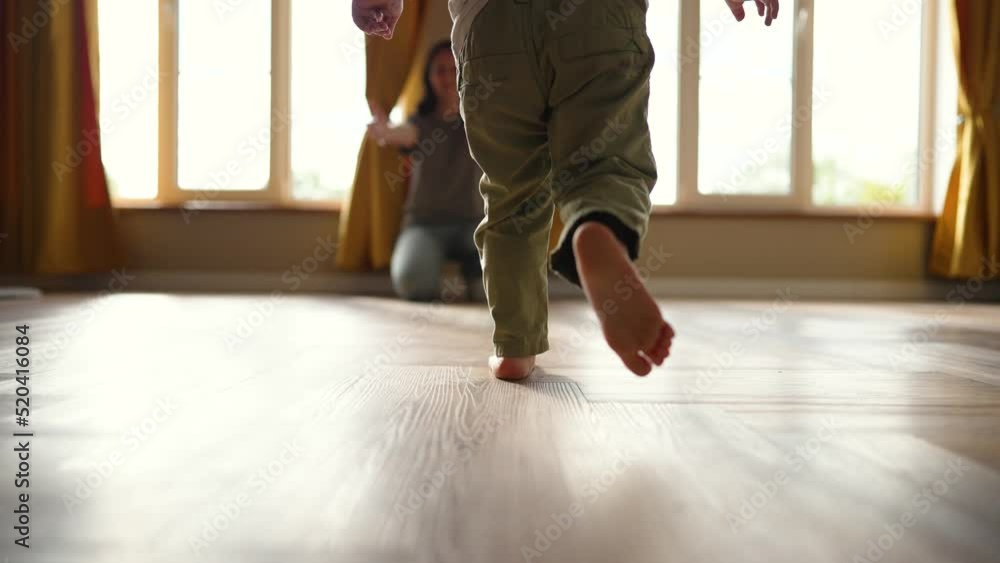 Vidéo Stock Happy family. Baby feet walk on floor towards mother. Child ...