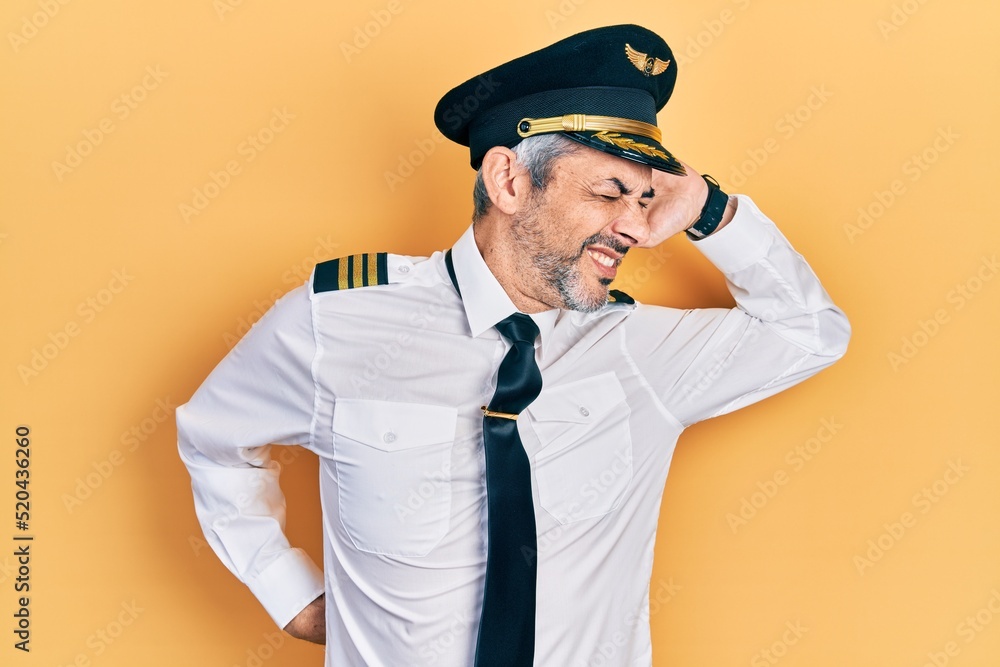 Handsome middle age man with grey hair wearing airplane pilot uniform ...