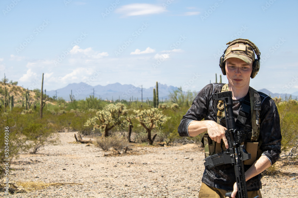 person holding ar15 pistol with holo sight and vertical grip walking ...