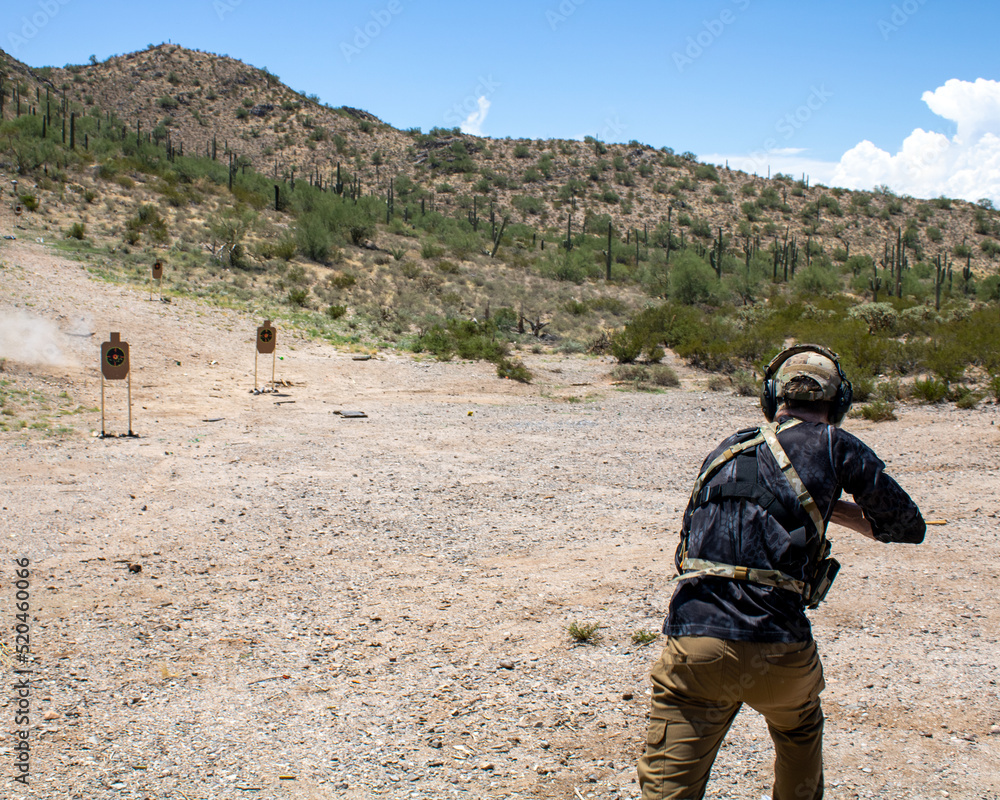 Person running during shooting drill practice wearing ear protection ...