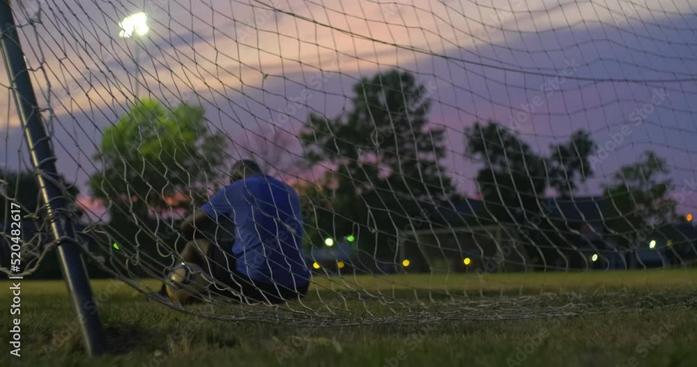 Vidéo Stock Behind the goal view of a sad man sitting on the goal line ...