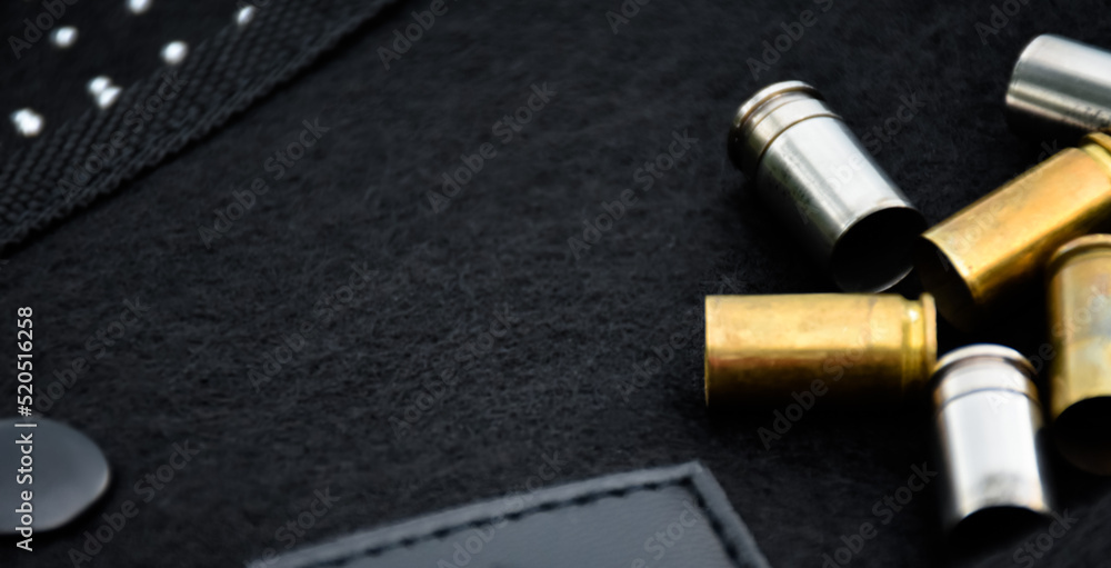 9mm pistol bullets and bullet shells on black leather background, soft ...