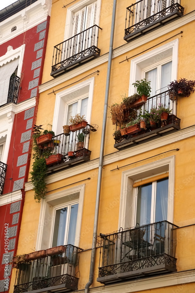 The facade of typical Spanish old house with beautiful balcony with ...