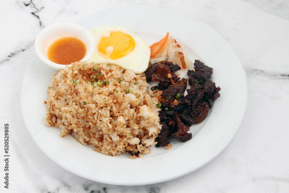 reshly cooked Filipino food called Tapsilog or thin beef slices, egg ...