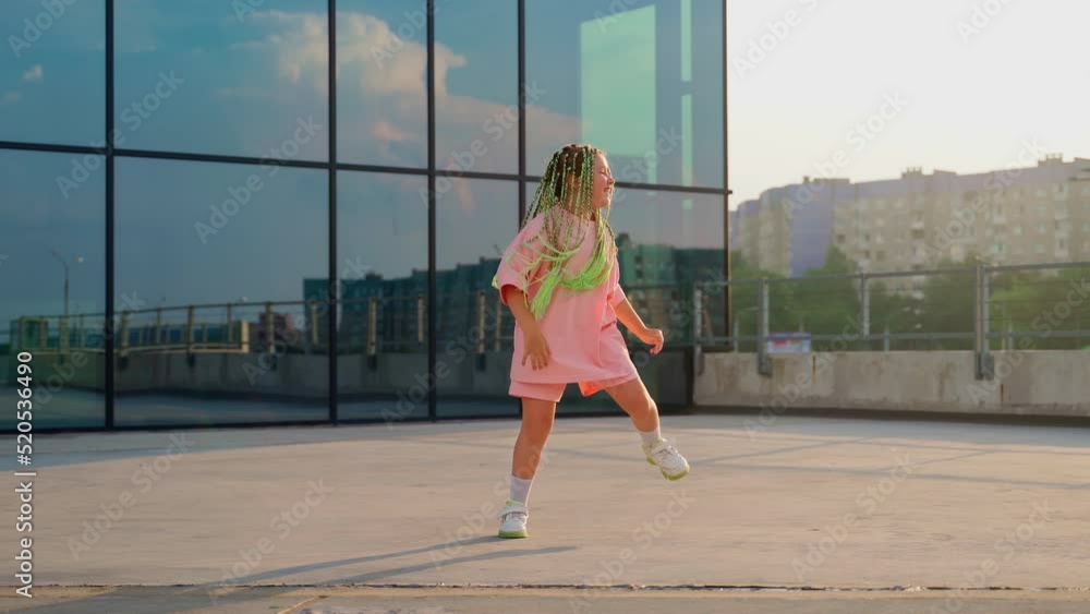 Child dancing outdoors. Professional girl dancer freestyle on glass ...