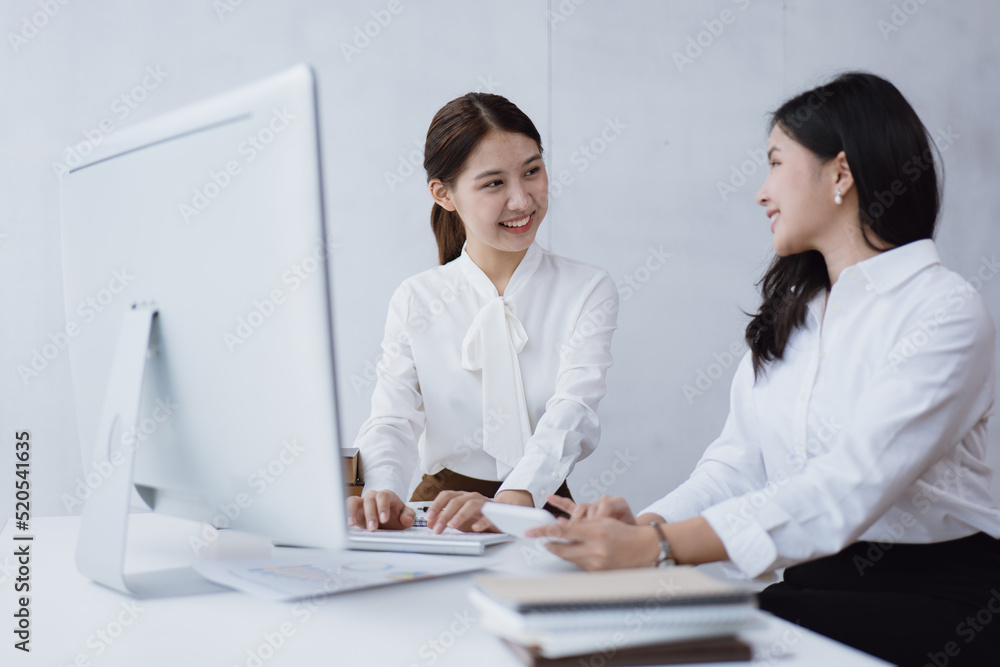 Young business women working on laptop with happy and smile face with ...