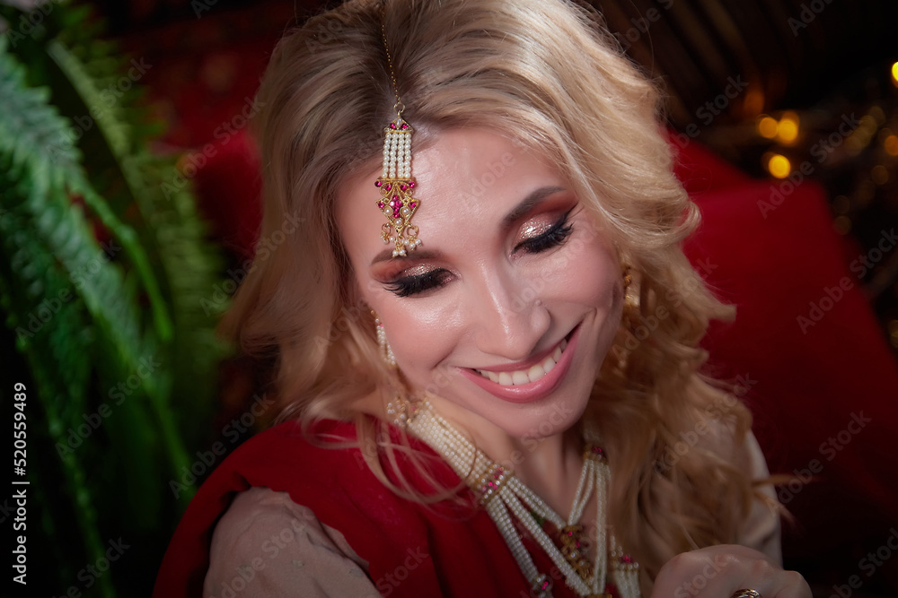 A beautiful European girl looking like an Arab woman in a red room in a ...