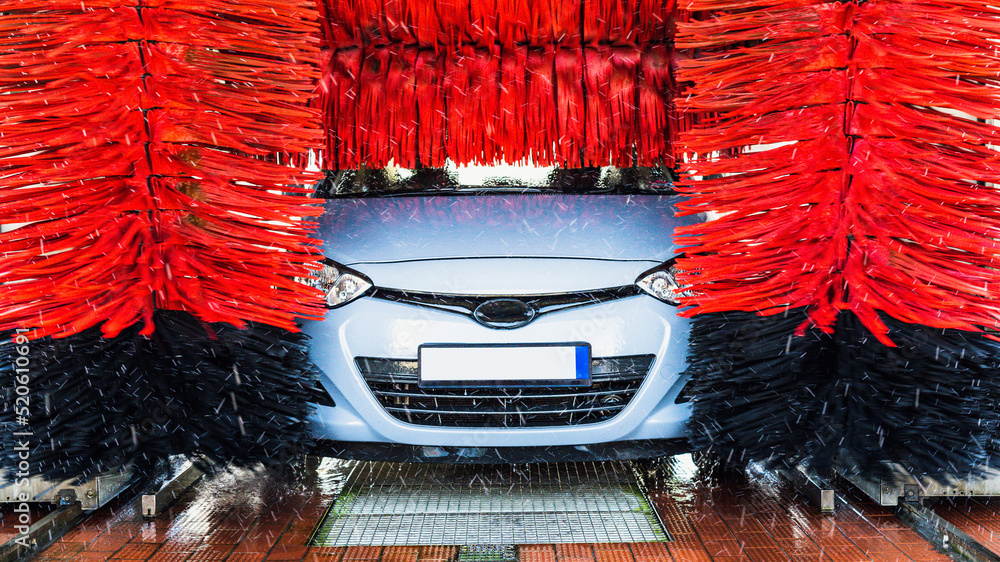 Automatic car wash. Auto brush washer clean blue car on automatic ...