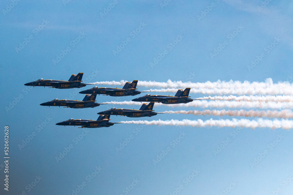 Six US Navy Blue Angel jets flying in formation leaving a vapor trail ...