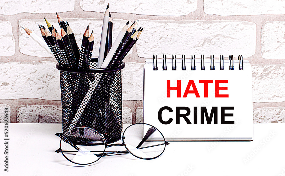 A workplace in the house with glasses, pencils in a stand and a ...