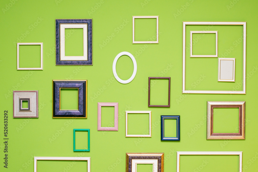 Wooden frames of different sizes and shapes on the green wall Stock ...