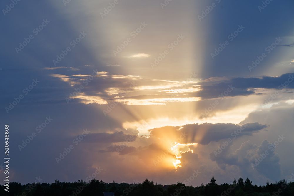 cloudy sunset sky with yellow sun rays with horizon, captured with 105mm lens Stock Photo ...