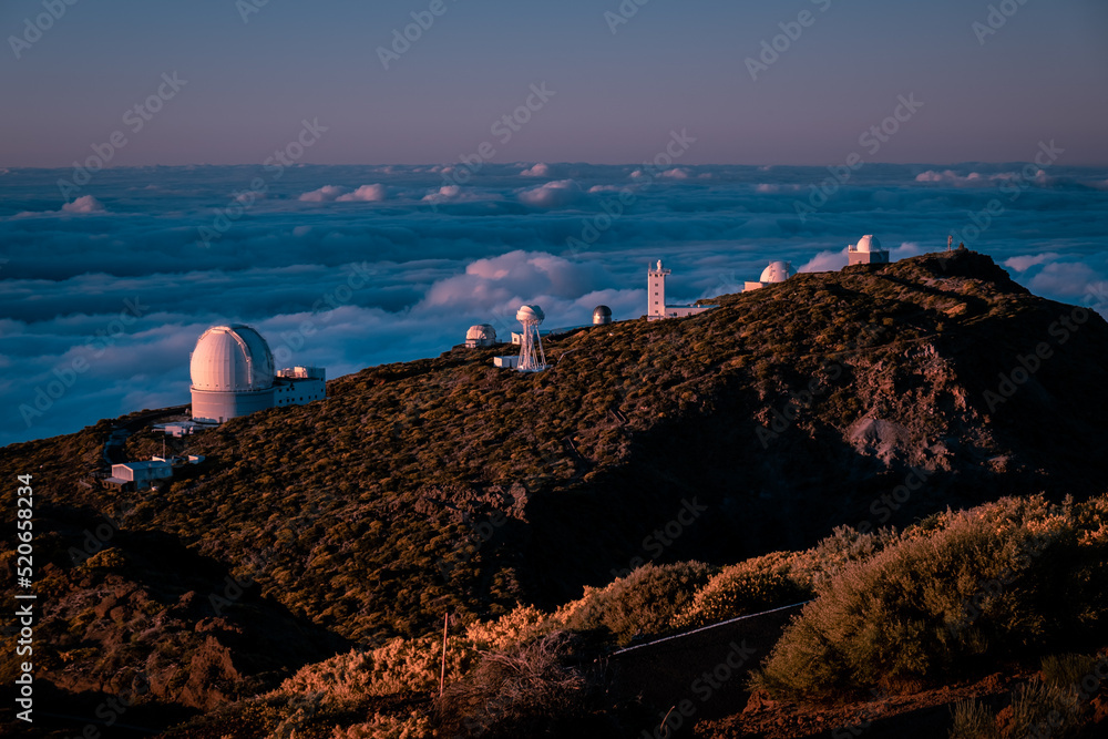 Structures of an astronomical observatory on top of a mountain above ...