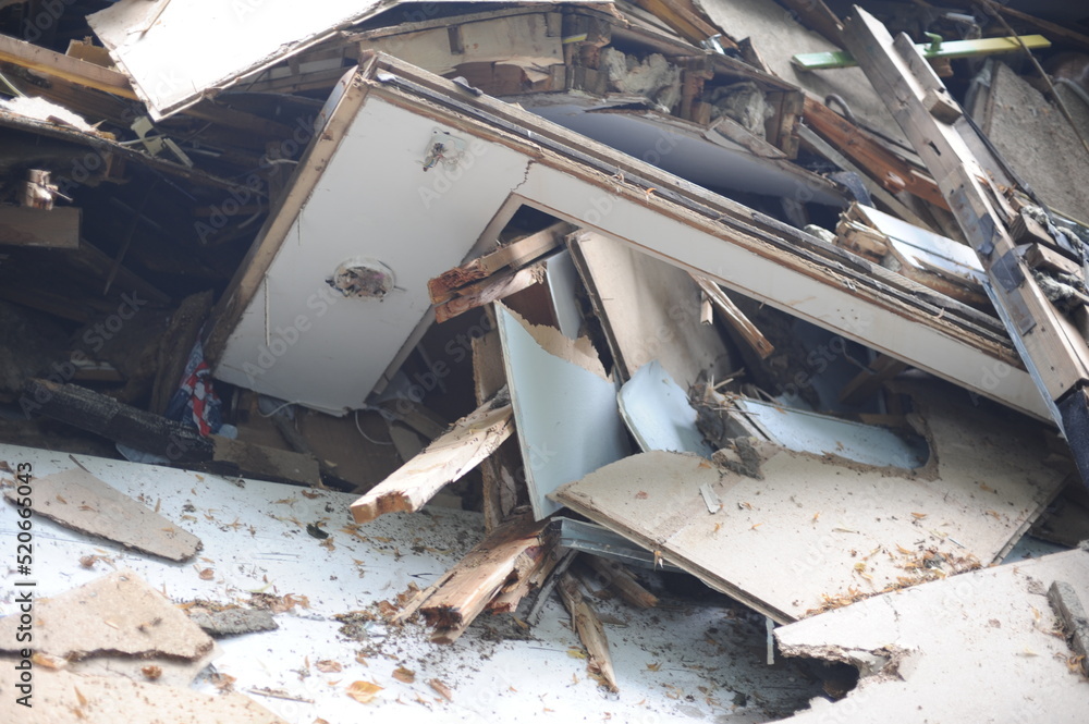 Debris and wooden remains and garbage pile on a stack on demolition ...