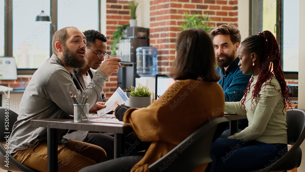 Diverse group of coworkers planning startup project in boardroom ...