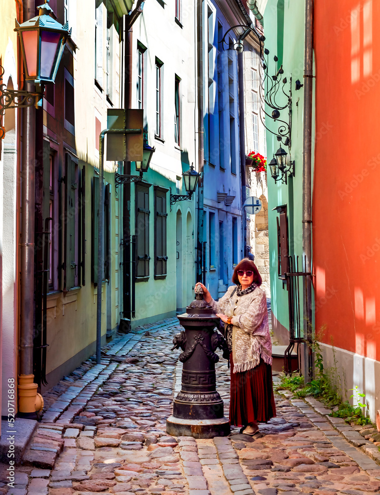 Senior woman in the medieval street of old Riga - the capital of Latvia ...