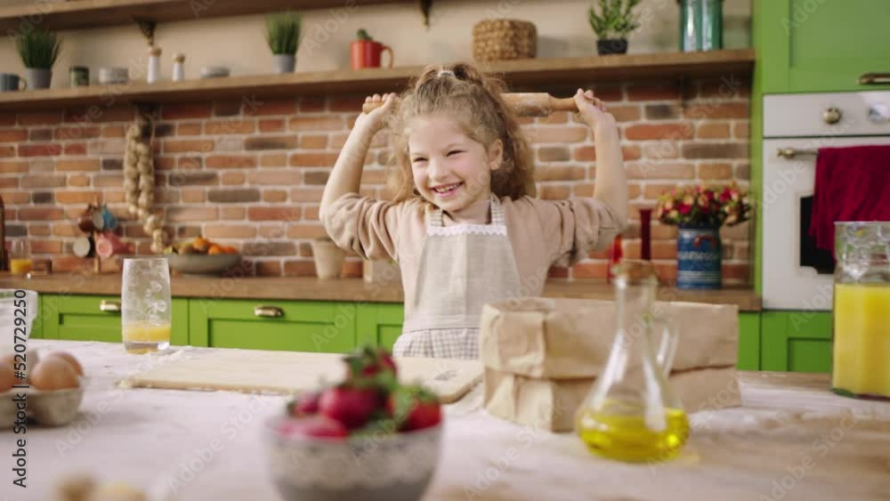 Charismatic and happy little girl while preparing the delicious dessert ...