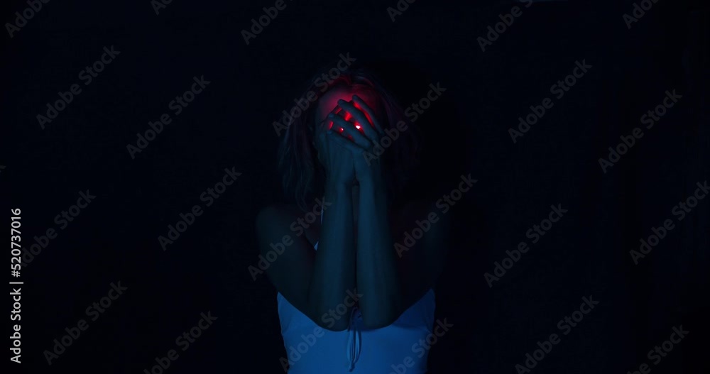 Woman holding a red neon light bulb hiding her face. Cinematic 4K ...