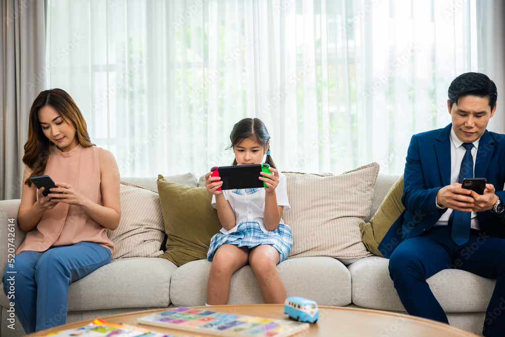 Family don't care about each other. Asian parents ignore their child and looking at their mobile ...