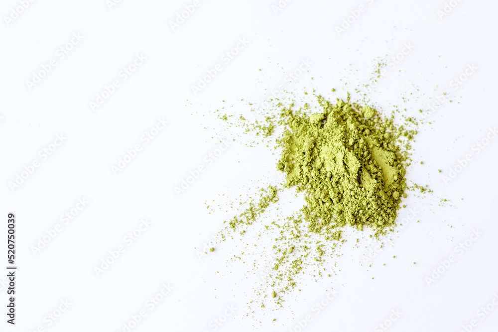 Matcha green tea powder on a white sheet of paper. Explosion on white ...