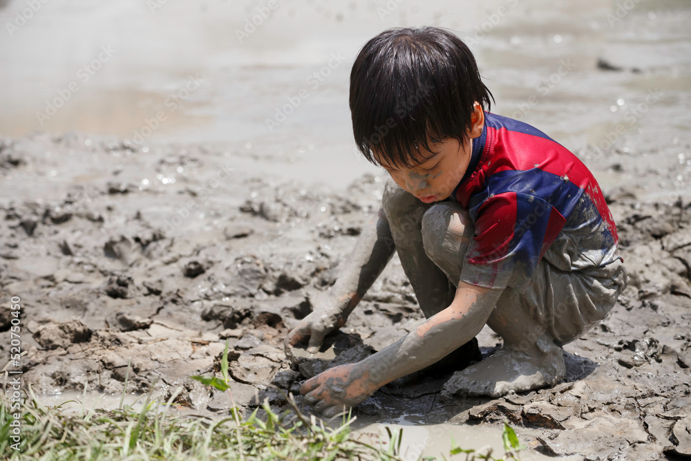 Little Boys Playing In Mud