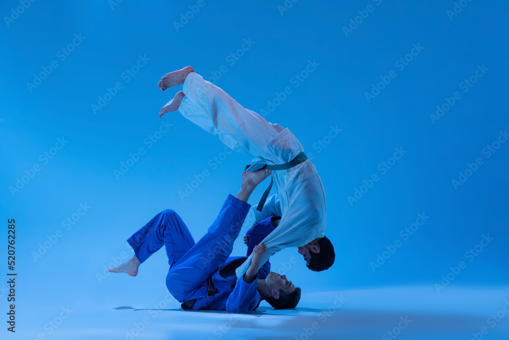 Dynamic portrait of professional judo coach training with athlete ...