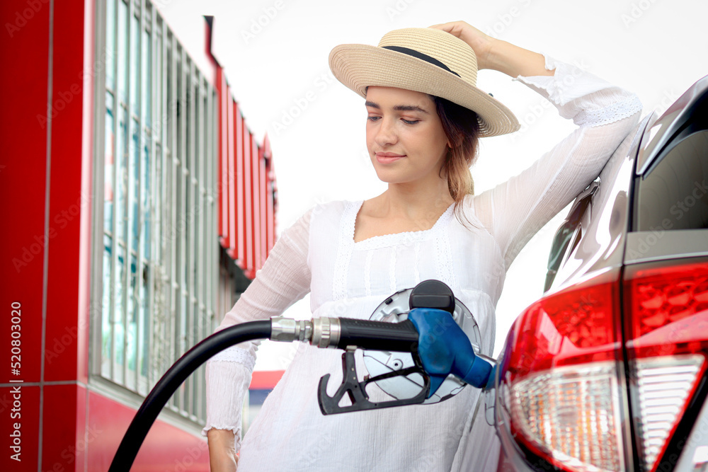 Happy smiling customer woman standing and waiting for filling up her ...