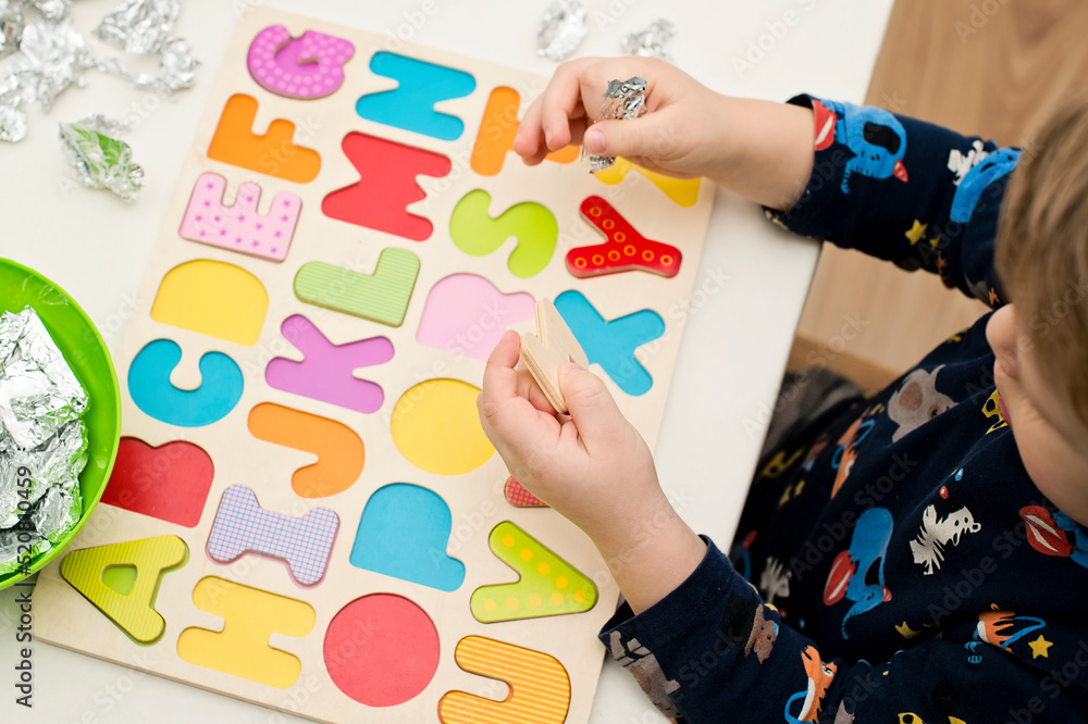 Two year boy playing with wooden alphabet letters board. Letters ...