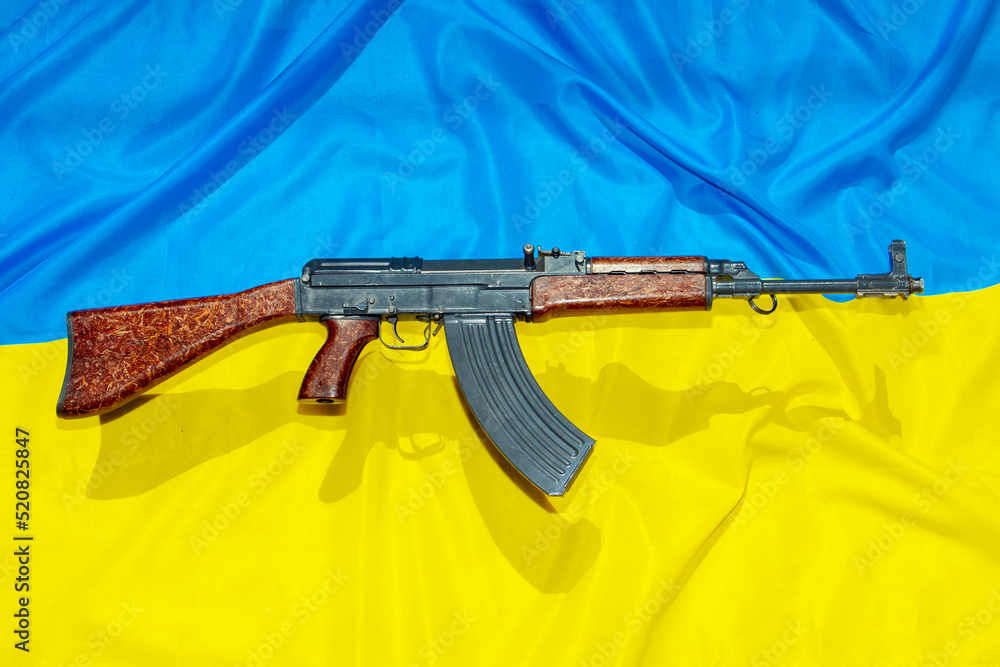The old assault rifle above the Ukrainian flag symbolizes resistance ...