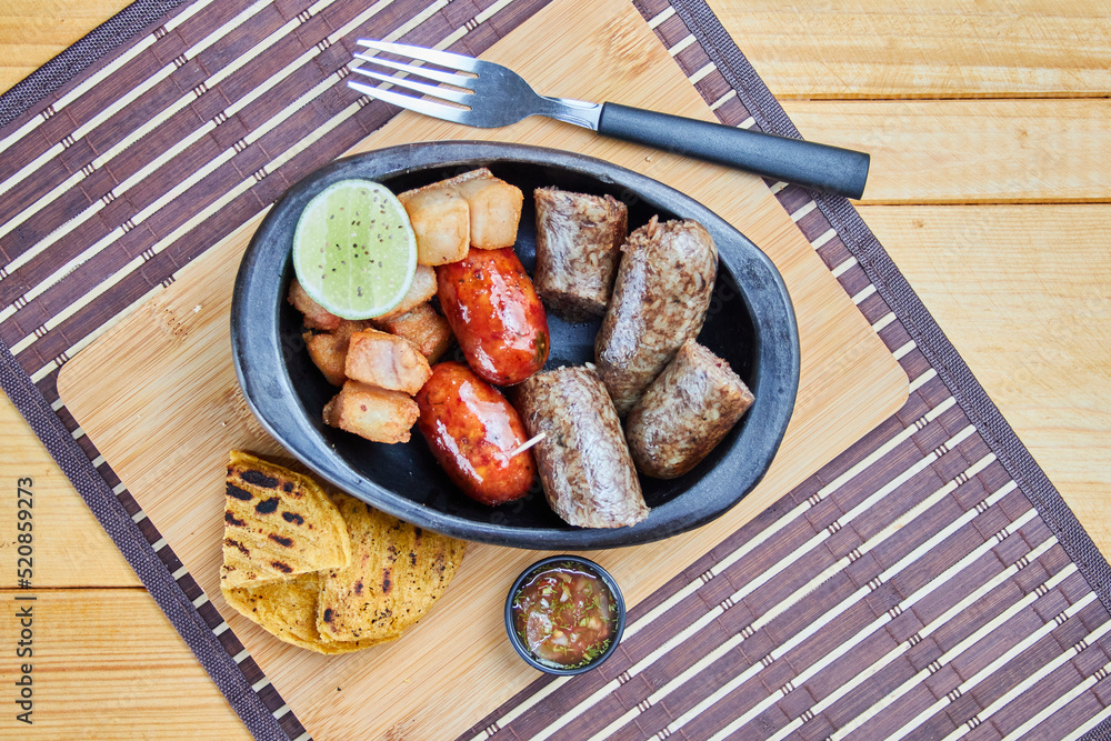 chirizos con morcilla y chicharrones, arepa, ají Stock-Foto | Adobe Stock