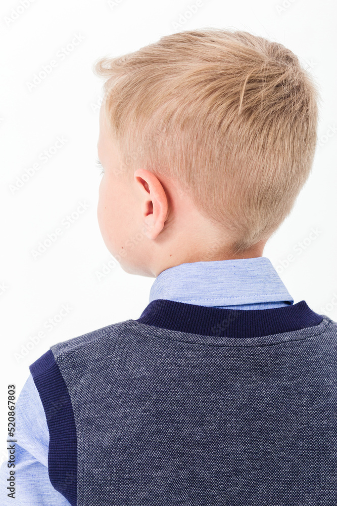 Boy, elementary school student posing in a school uniform on a white ...