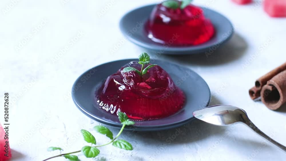 Table setting of two servings of watermelon jelly with mint and ...