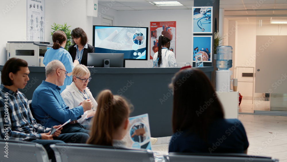 Busy hospital reception with diverse group of patients in waiting room ...