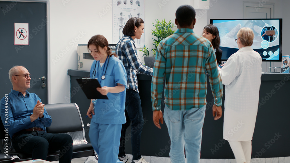 Busy reception desk with many patients waiting to attend consultation ...