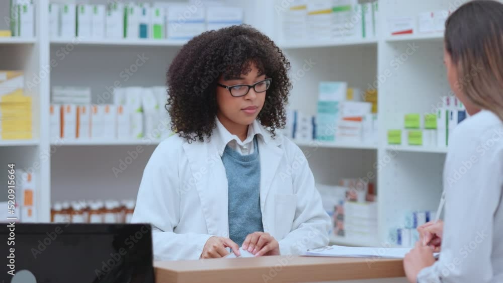 Medical professional helping patient at counter to buy medicine at drug ...