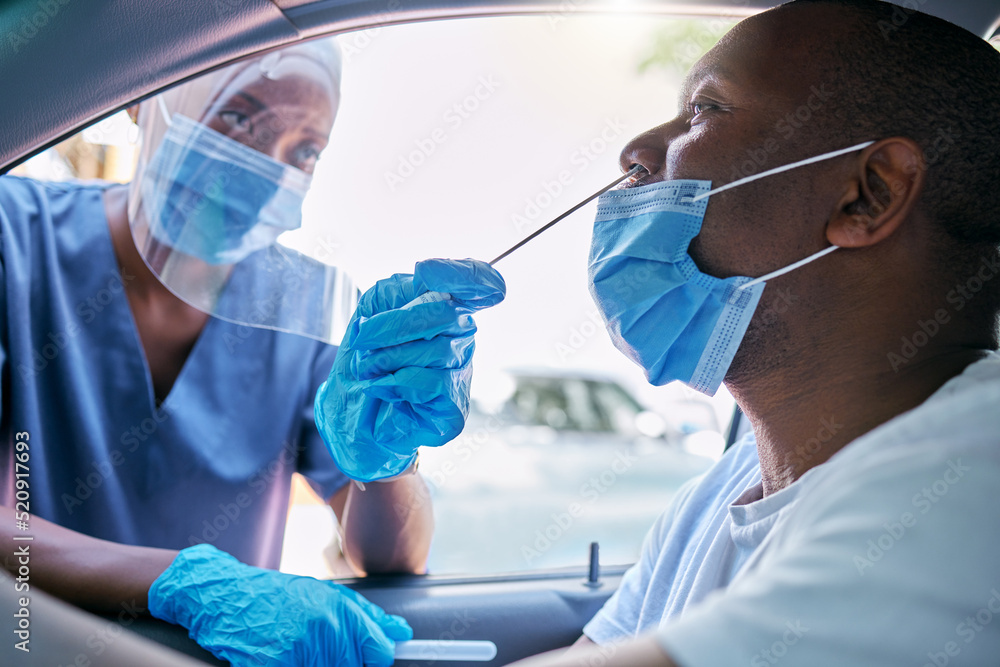 Doctor or nurse doing covid or corona virus test at a drive thru on a ...