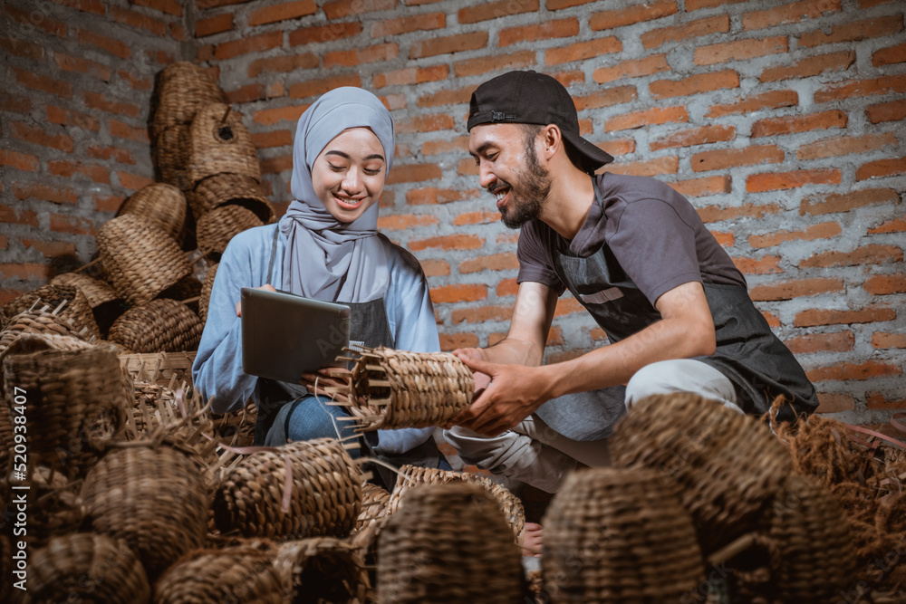 craftswoman in veil holding tablet and craftsman checking water ...