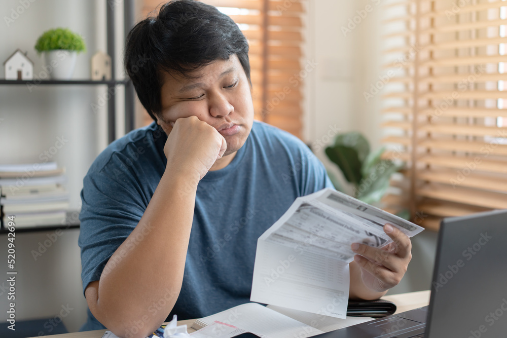 Asian sad and worried man going crazy with bill payment amount ...