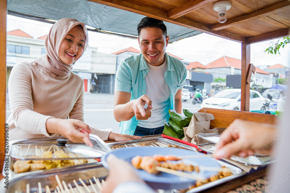 muslim couple ordering food to break fasting in traditional food market ...