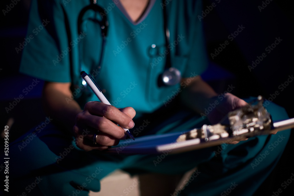 Crop anonymous doctor in uniform with stethoscope sitting on staircase ...