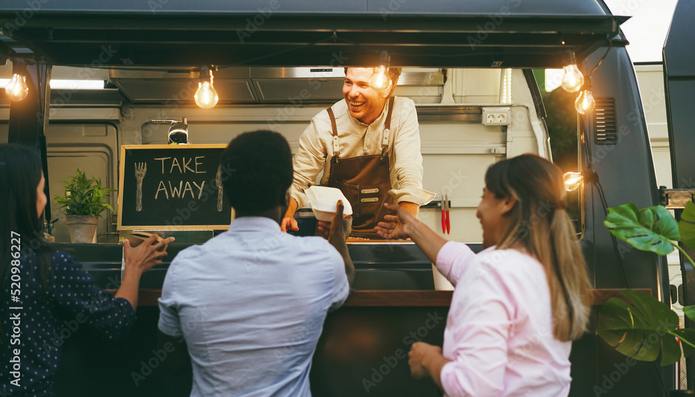 Multiracial people ordering food at counter in food truck outdoor ...