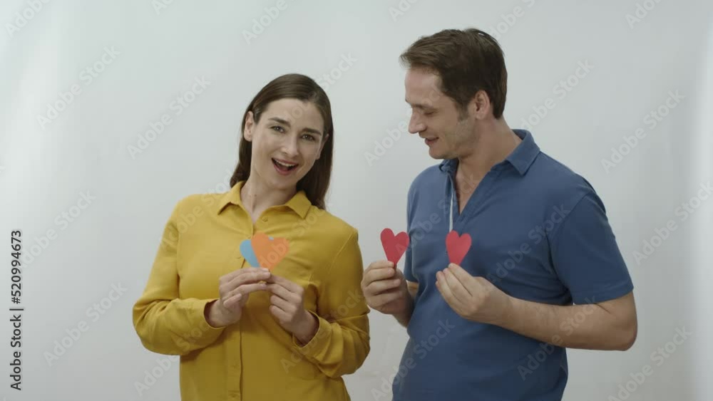 Vidéo Stock Young couple dancing, celebrating with paper hearts on ...