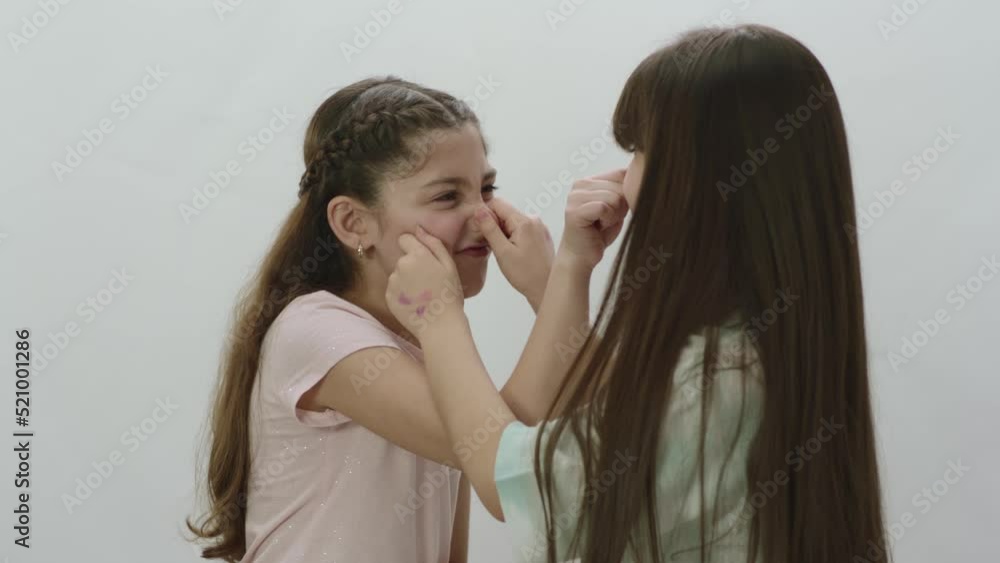 2 little girlfriends who love each other very much pinch each other's ...