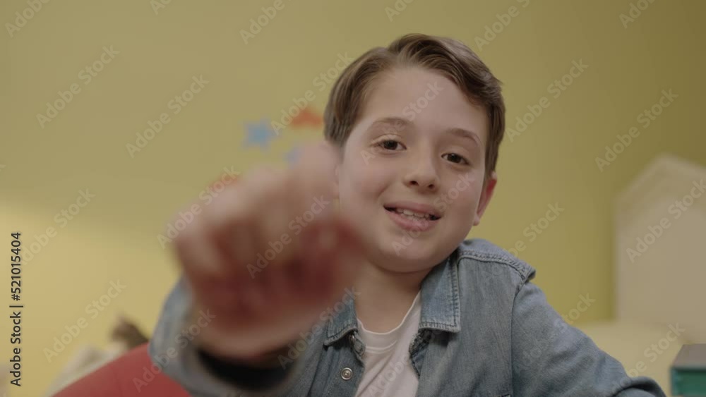 Little boy changes pages with his finger on his cell phone or computer ...