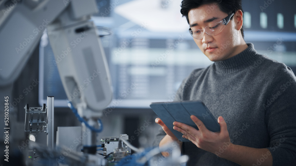 Student Holding Tablet and Controlling Robot Hand Moving at Different ...
