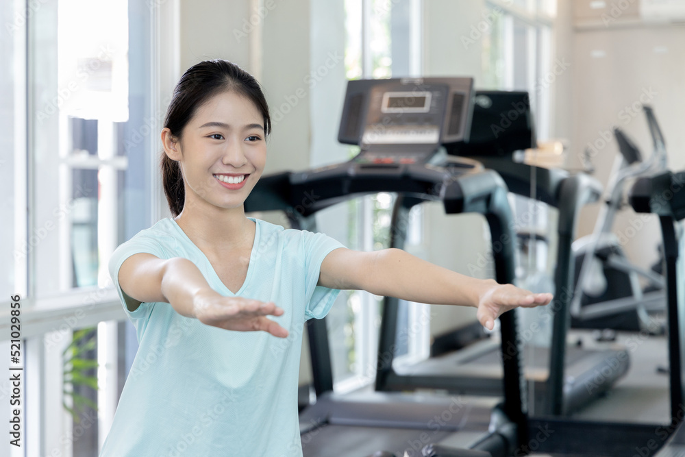 Beautiful and shapely Asian woman working out in the gym, Play exercise ...